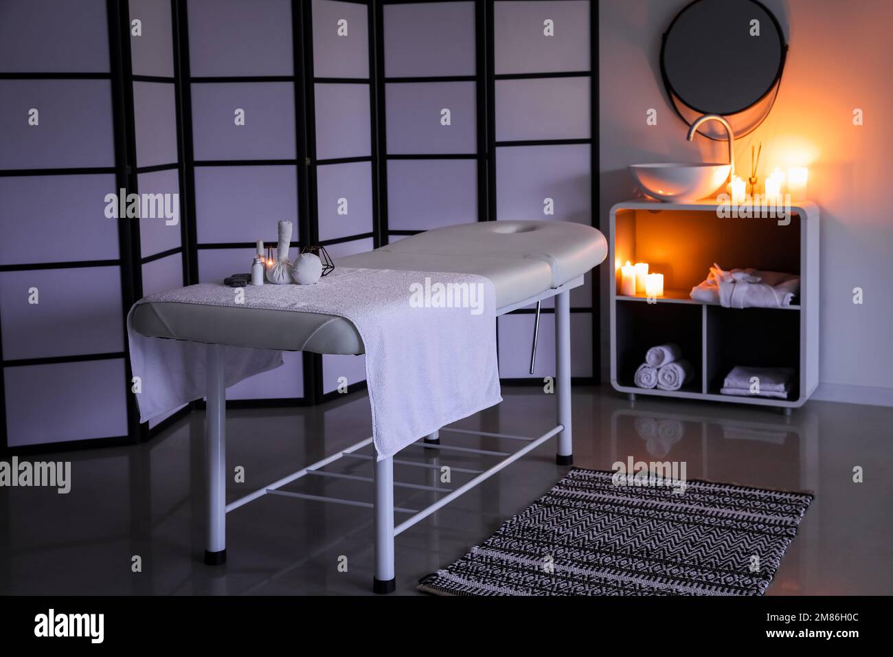 Interior of dark spa salon with couch, sink and folding screen Stock ...