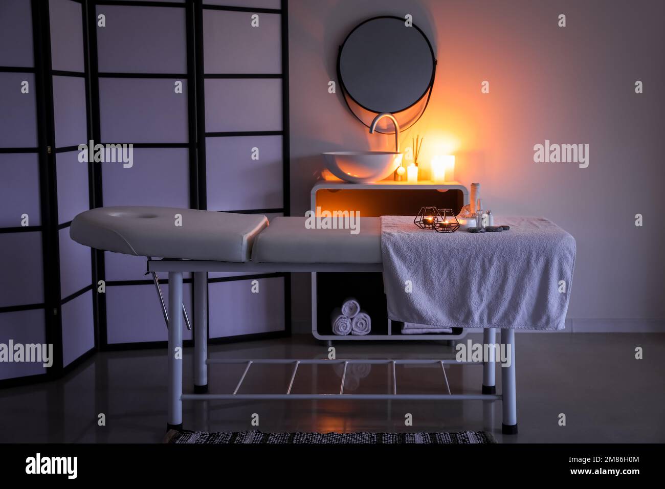 Interior of dark spa salon with couch, sink and folding screen Stock ...
