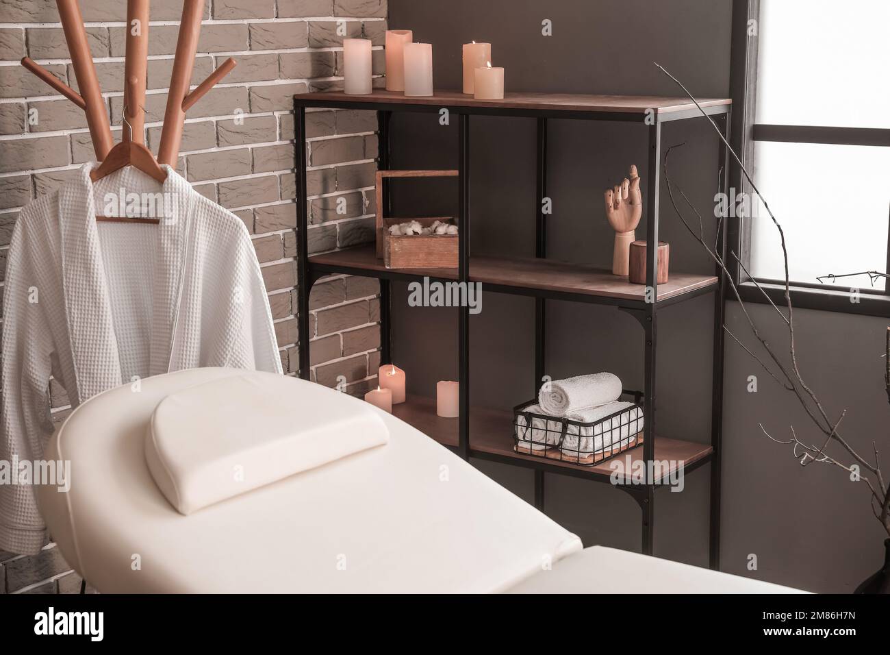 Interior of spa salon with couch, shelving unit and bathrobe Stock ...