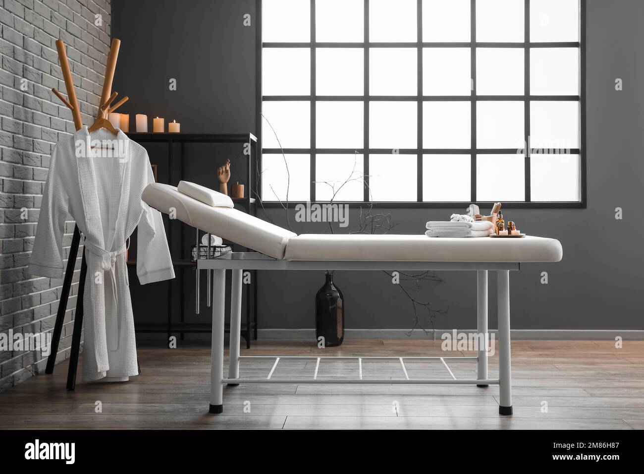 Interior of spa salon with couch, shelving unit and bathrobe Stock ...