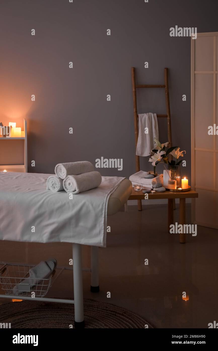 Interior of dark spa salon with couch, table and ladder Stock Photo - Alamy