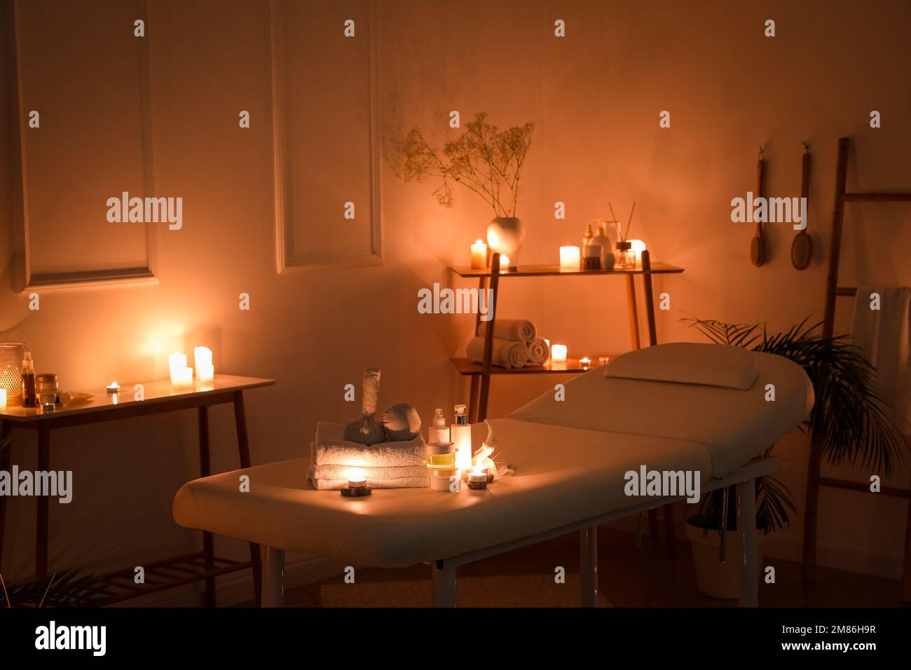 Interior of dark spa salon with couch, burning candles and table Stock ...