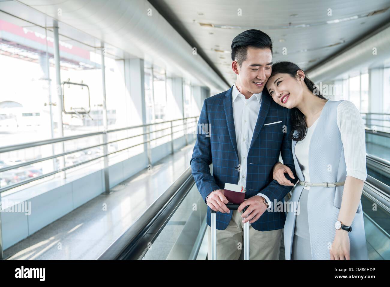 Young couples the elevator movement at the airport Stock Photo - Alamy