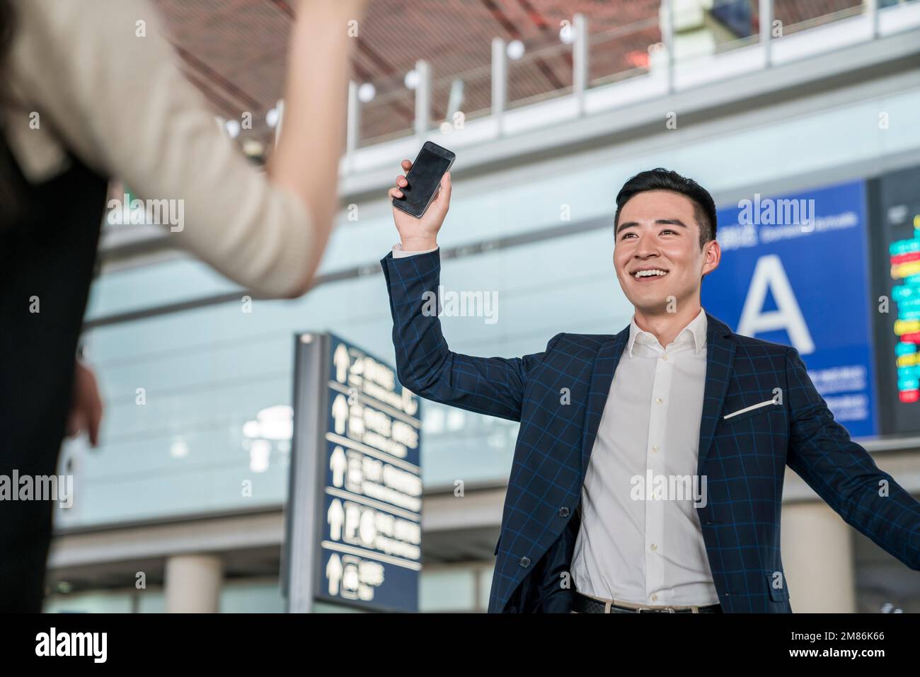 Young couple reunited at the airport Stock Photo - Alamy