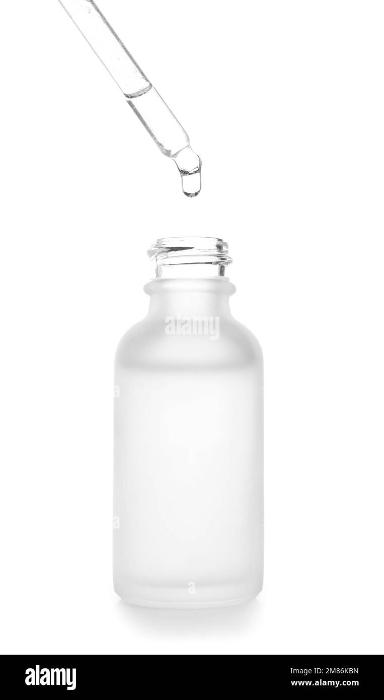 Dripping of serum from pipette into bottle on white background Stock ...