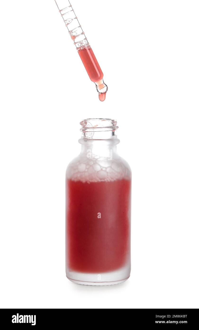 Dripping of serum from pipette into bottle on white background Stock ...
