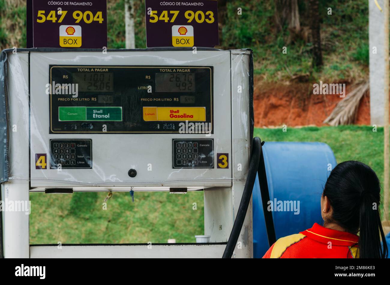 Minas Gerais, Brazil - January 11, 2022: A woman servicing a Shell ...