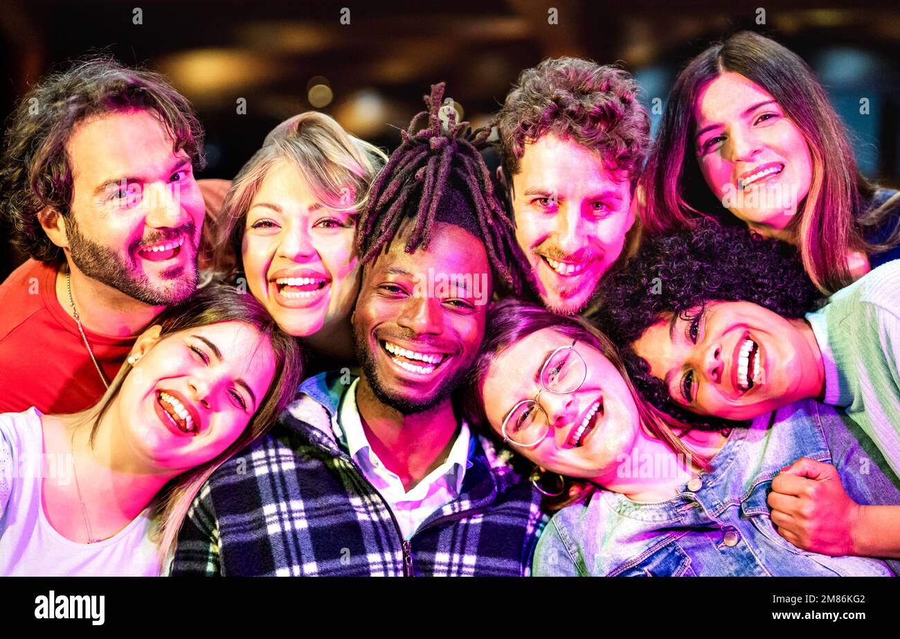 Multicultural men and women taking funny selfie with happy faces - Social gathering life style ...