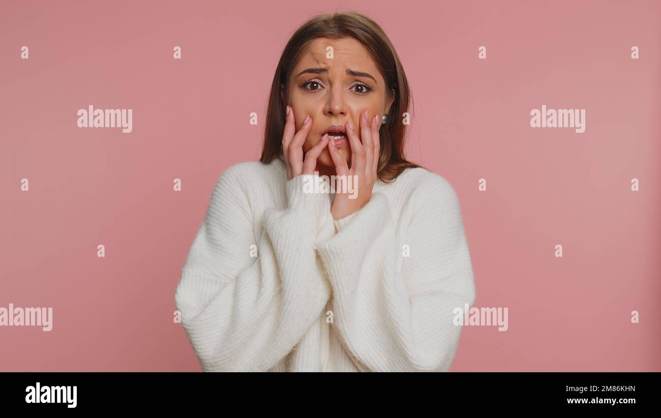 Upset scared frightened young woman biting nails, feeling worried ...