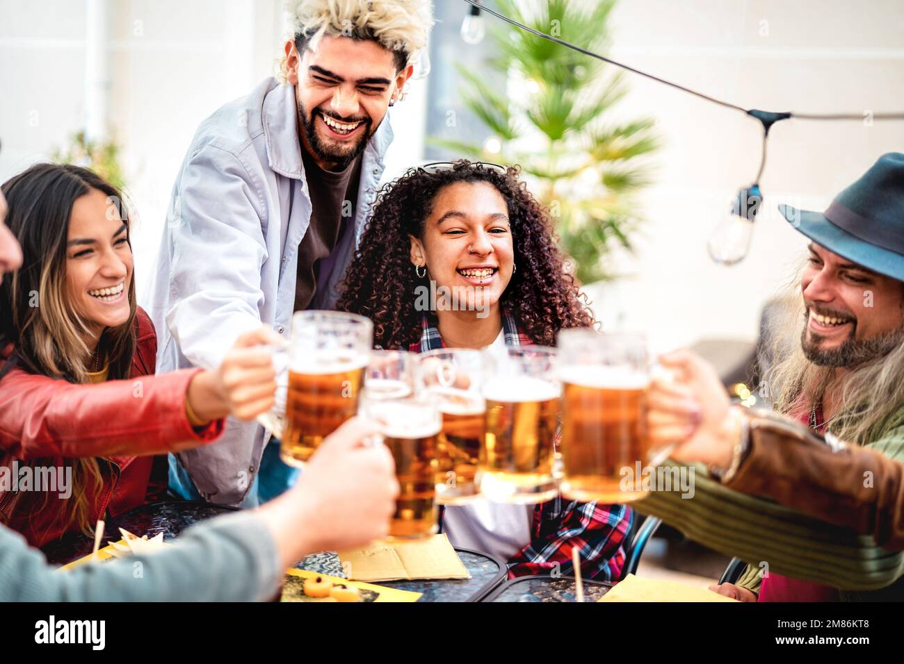 Young happy friends drinking and toasting beer at brewery bar - Food ...