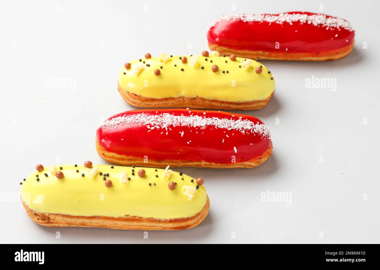 Delicious glazed eclairs isolated on white background Stock Photo - Alamy