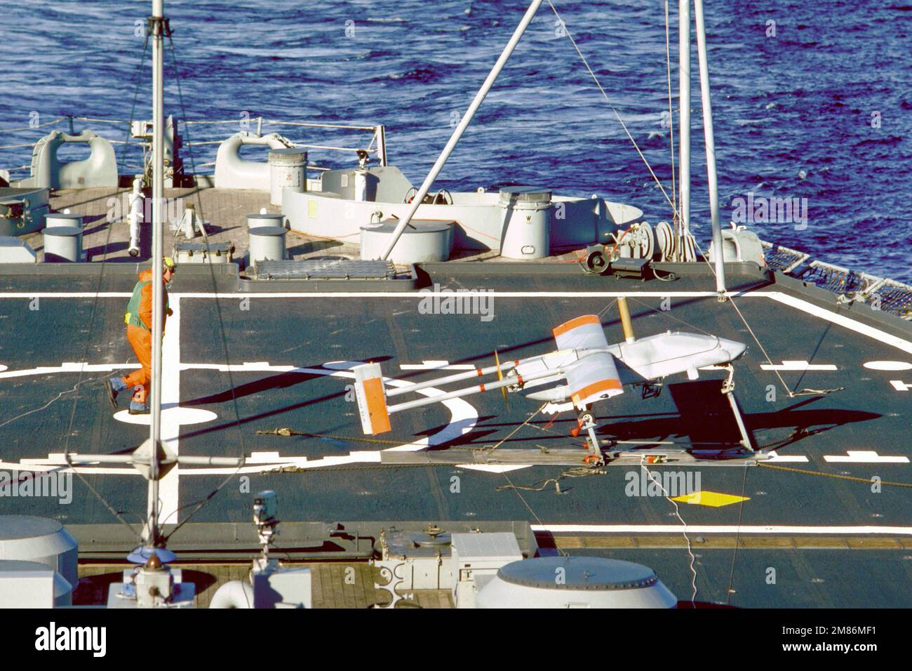 A crewman performs a final pre-launch check on a Pioneer I remotely ...