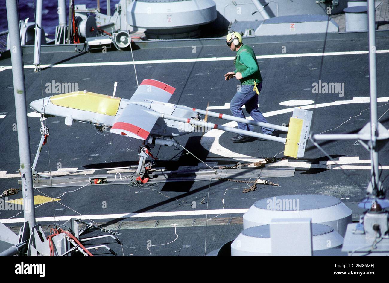 A crewman performs a final pre-launch check on a Pioneer I remotely ...