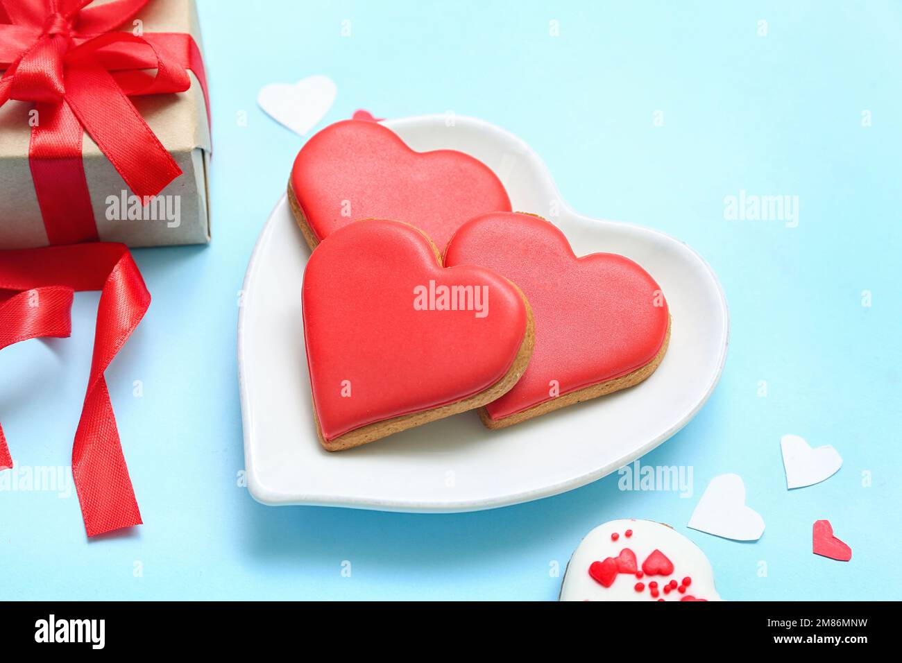 Plate with tasty heart shaped cookies on color background. Valentine's ...