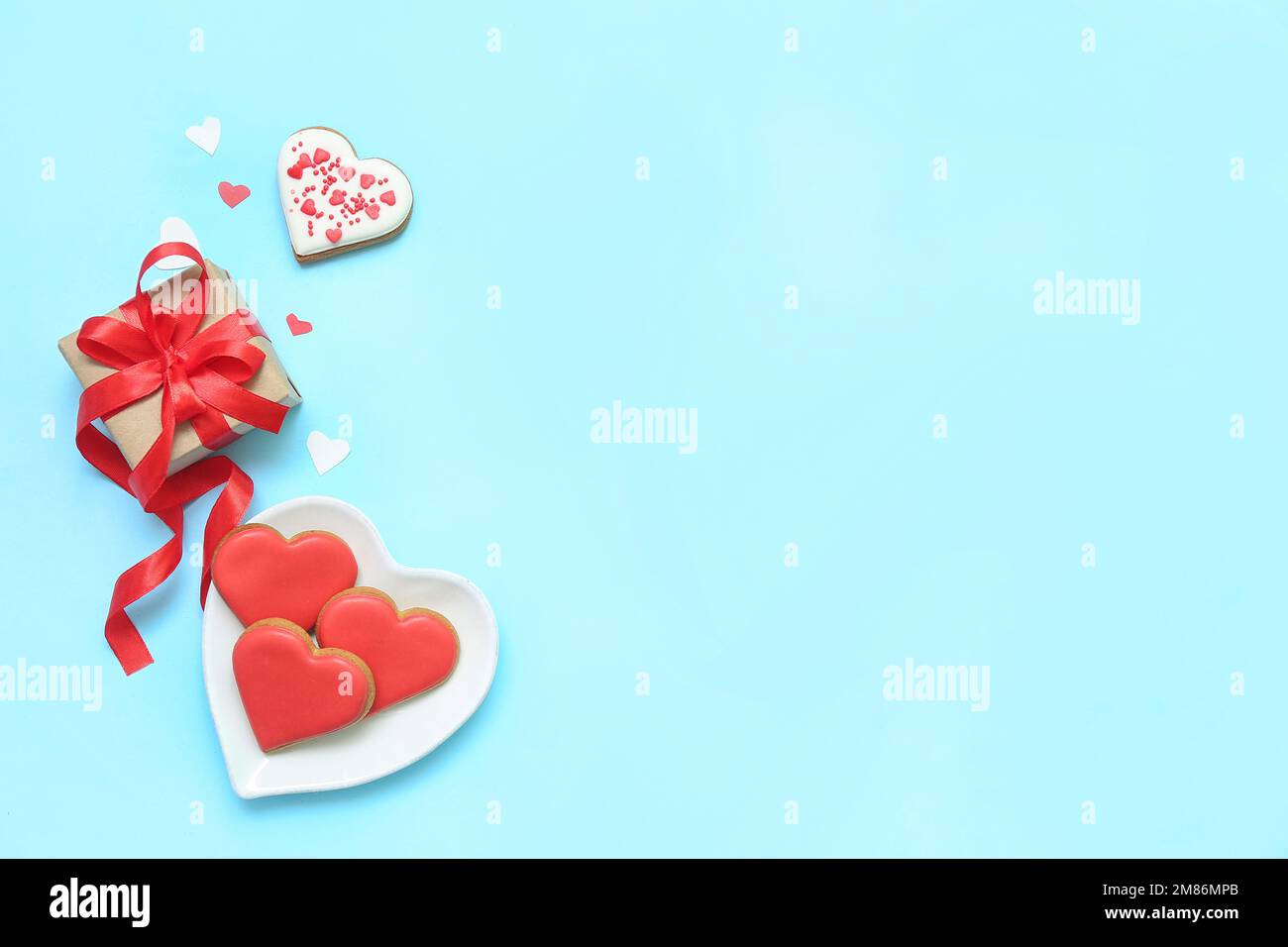 Composition with tasty heart shaped cookies and gift box on color ...