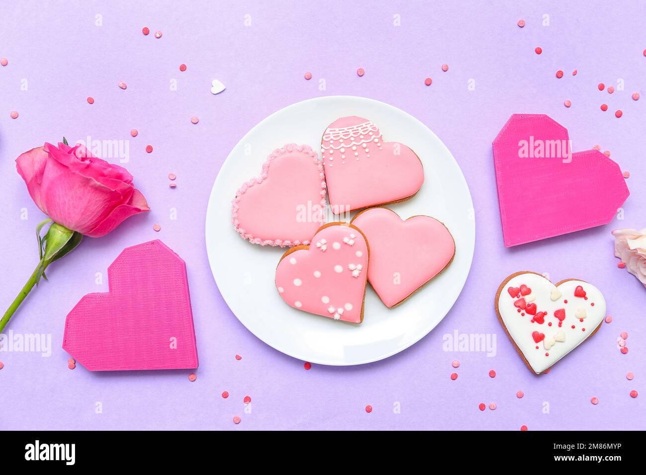Composition with tasty heart shaped cookies, rose flower and decor on ...