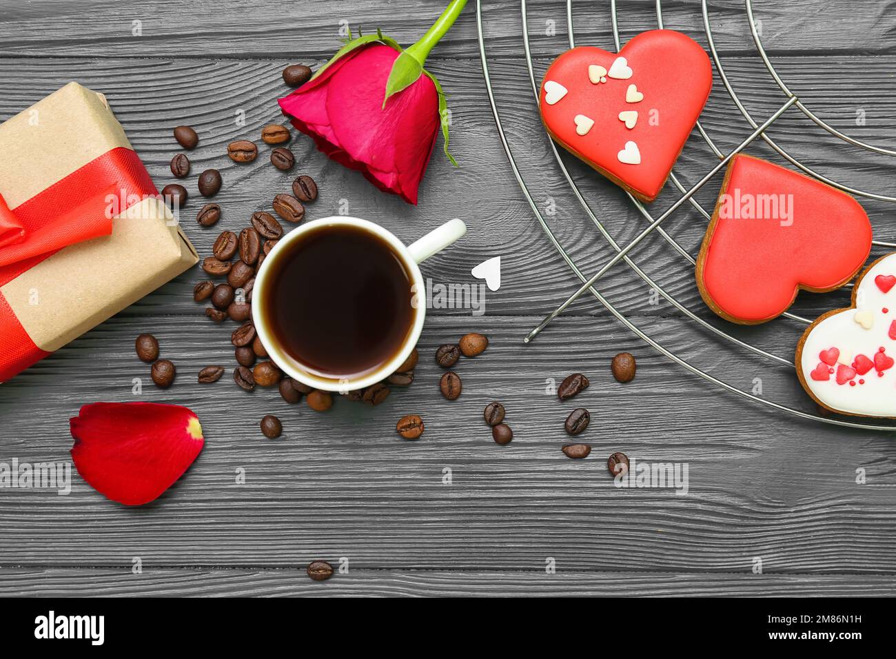 Composition with tasty heart shaped cookies, gift box and cup of coffee ...