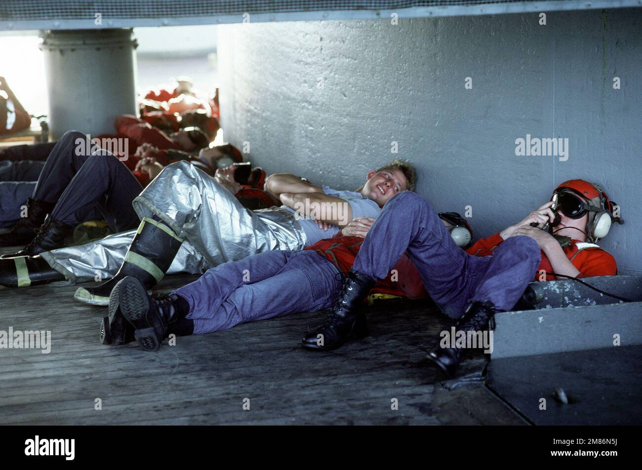 Members of a fire party relax beneath one of the Mark 7 16-inch/50 ...