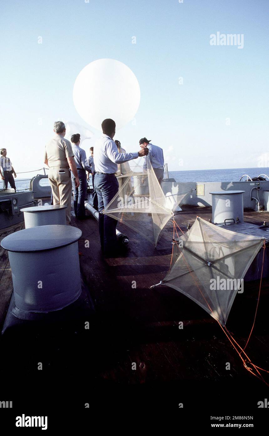 Crew members release a weather/wind velocity balloon prior to a remote ...
