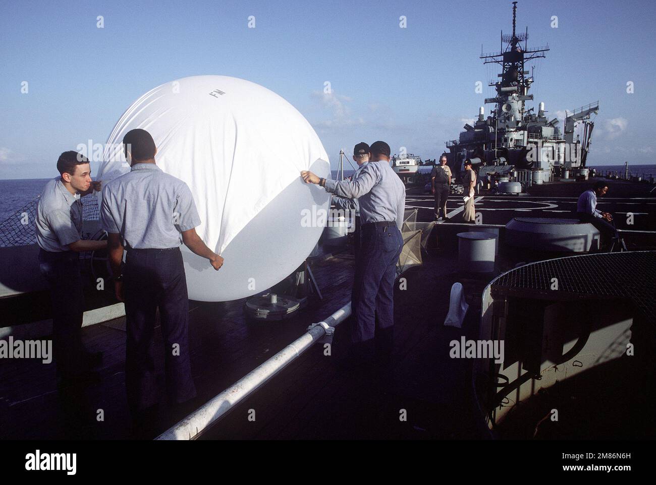 Crew members prepare to release a weather/wind velocity balloon prior ... Crew members prepare to release a weather/wind velocity balloon prior ...