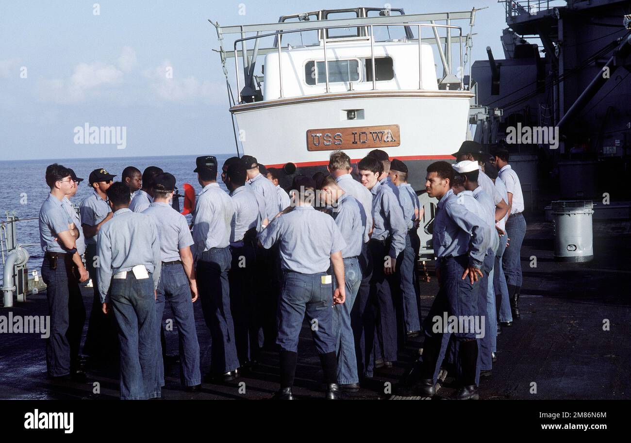 Crew members muster on the stern of the battleship USS IOWA (BB-61 ...