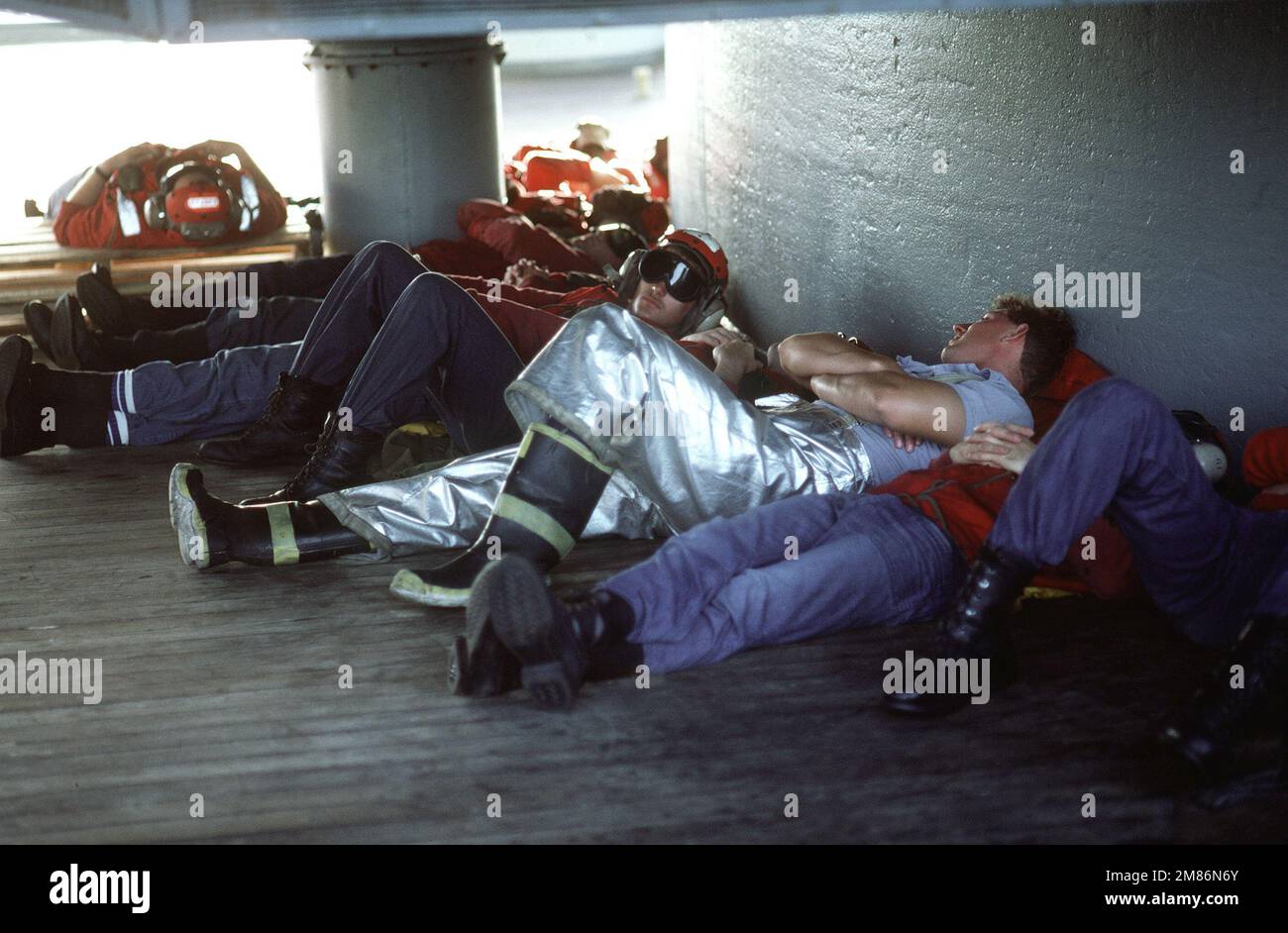 Members of a fire party relax beneath one of the Mark 7 16-inch/50 ...
