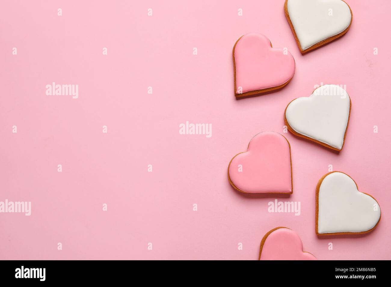 Different heart shaped cookies on pink background. Valentines Day ...