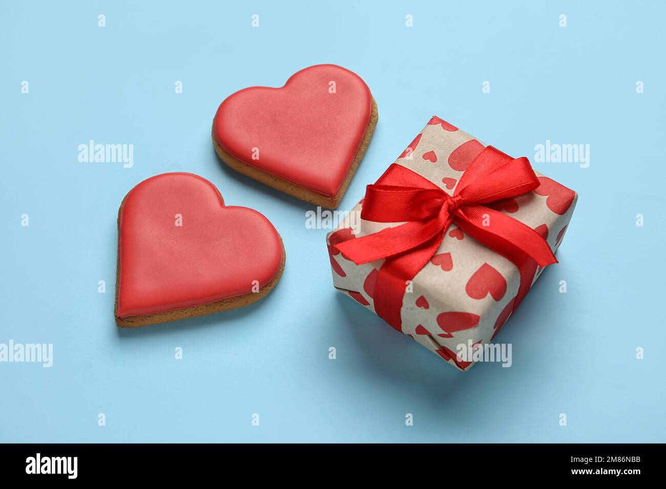 Sweet heart shaped cookies and gift box on color background. Valentines ...