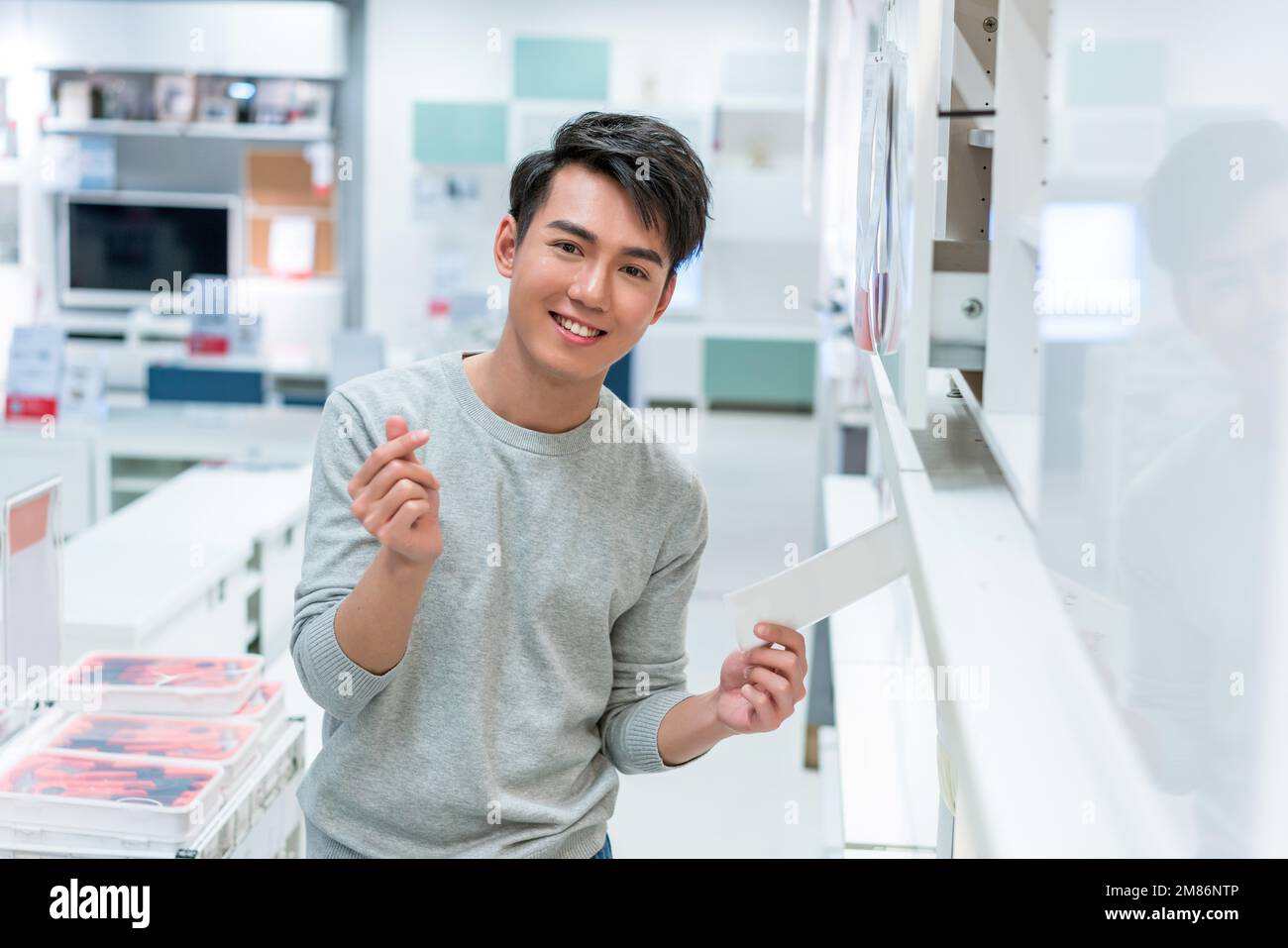 Young men choose furniture Stock Photo - Alamy