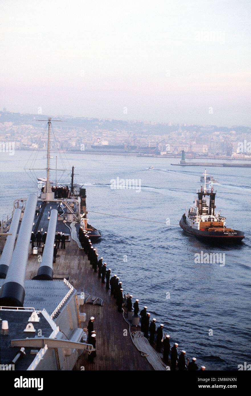 Crew members aboard the battleship USS MISSOURI (BB-63) man the rails ...