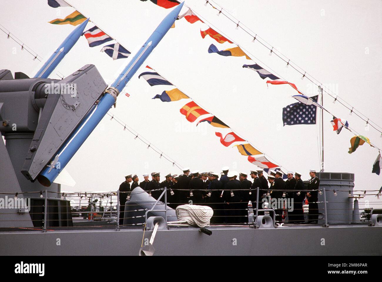 Visiting Chinese naval personnel are briefed on the deck of the guided ...