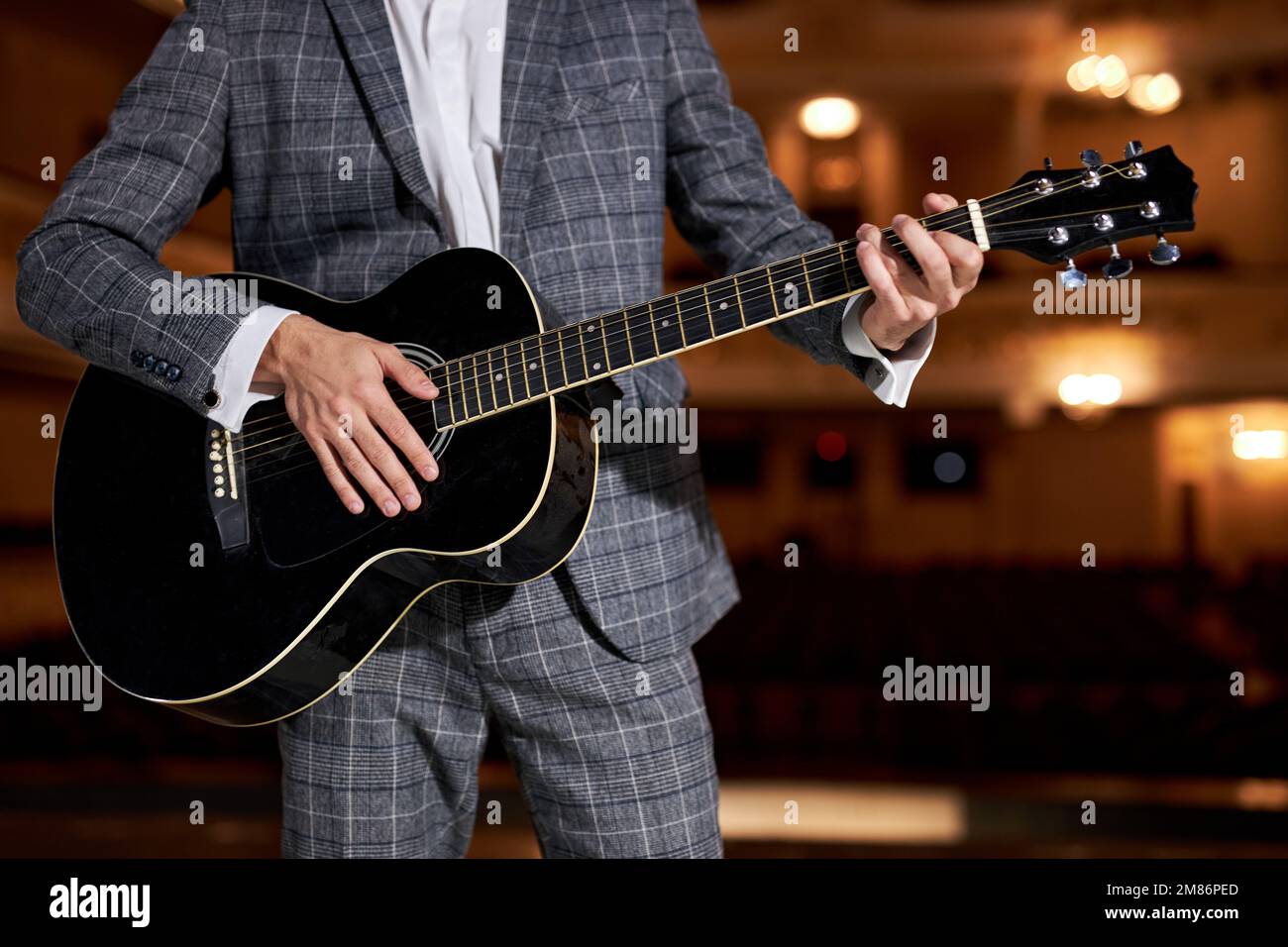 Cropped european Man in elegant classic suit plays and sings while ...