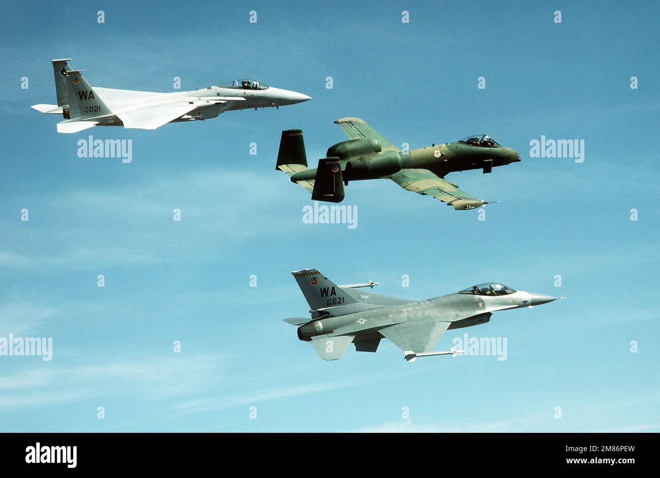 An air-to-air right side view of an F-15 Eagle aircraft, an A-10A ...
