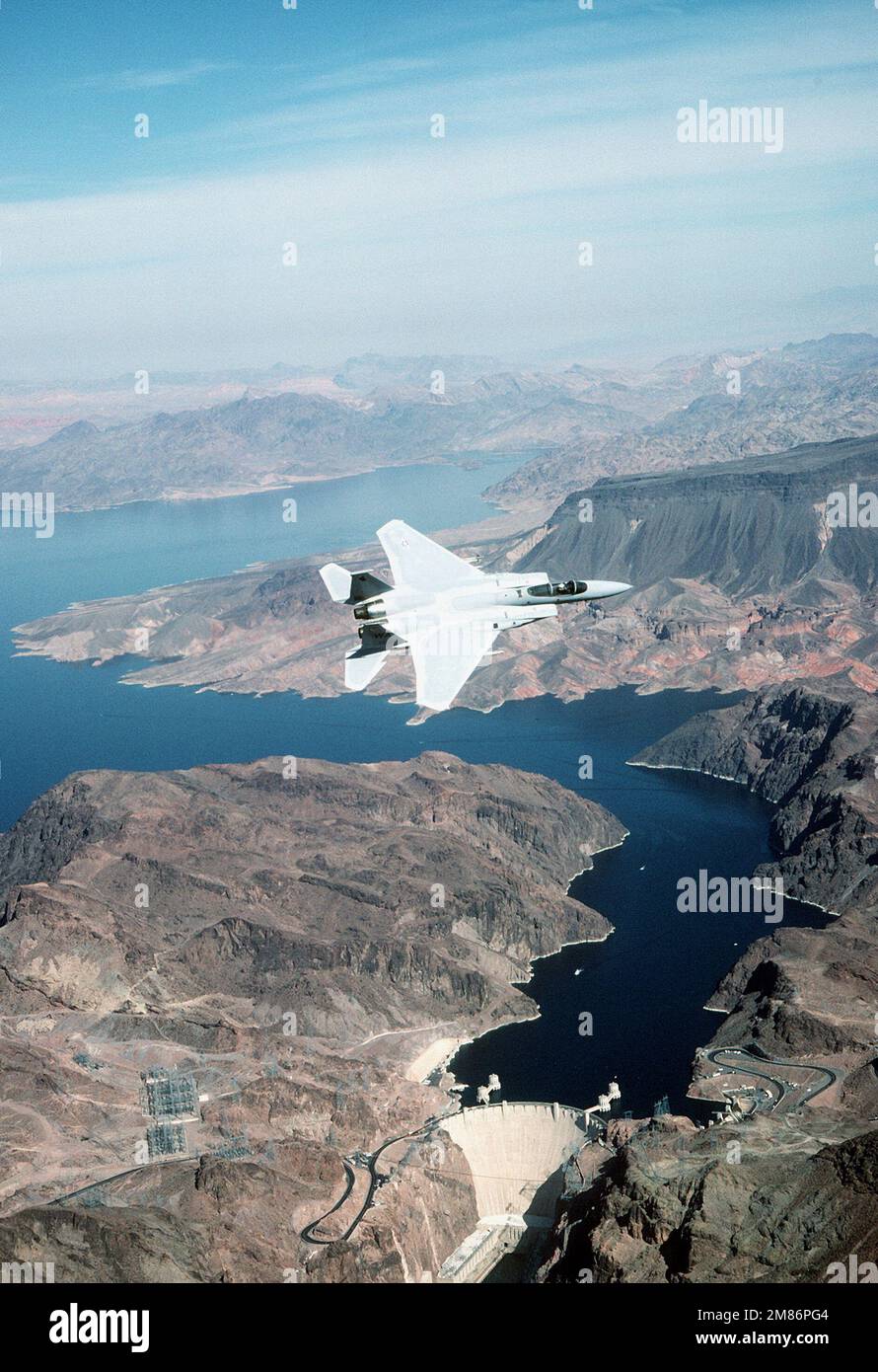 An air-to-air view of an F-15 Eagle aircraft banking to the right over ...