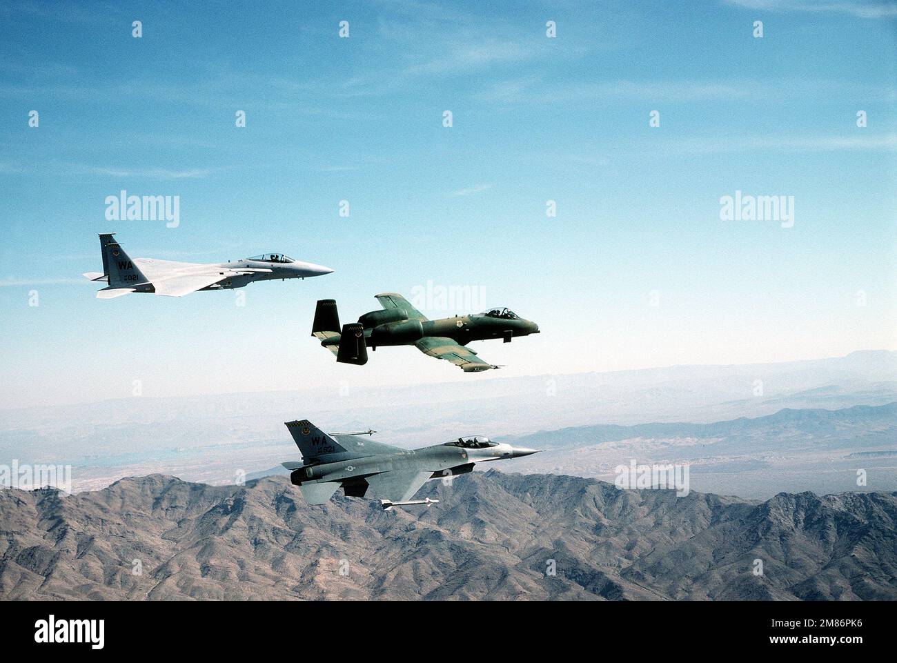 An air-to-air side view of an F-15 Eagle aircraft, an A-10A Thunderbolt ...