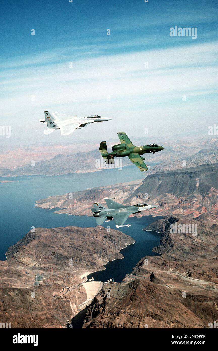 An air-to-air right side view of an F-15 Eagle aircraft, an A-10A ...