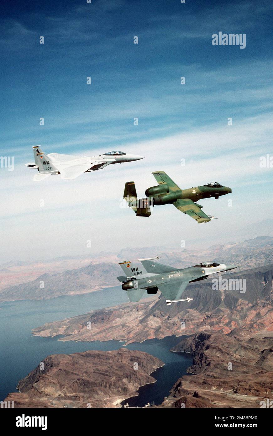 An air-to-air right side view of an F-15 Eagle aircraft, an A-10A ...