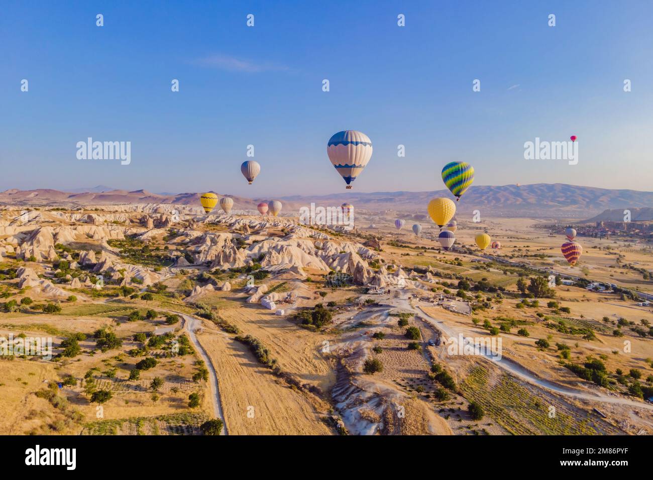 Colorful hot air balloons flying over at fairy chimneys valley in ...