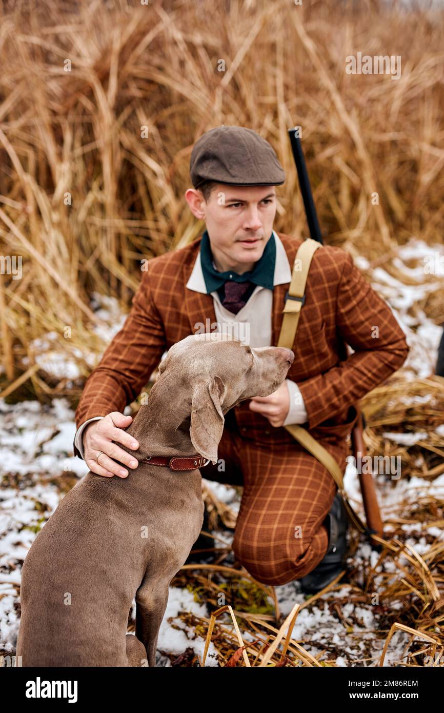 Hunting period, autumn season open. man hunter with gun in fashionable ...