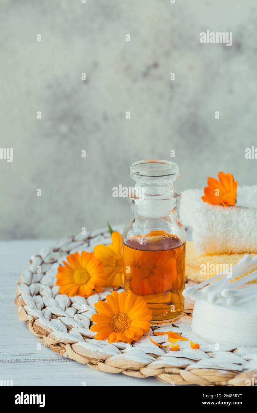 A bottle of pot marigold tincture or infusion with fresh calendula ...