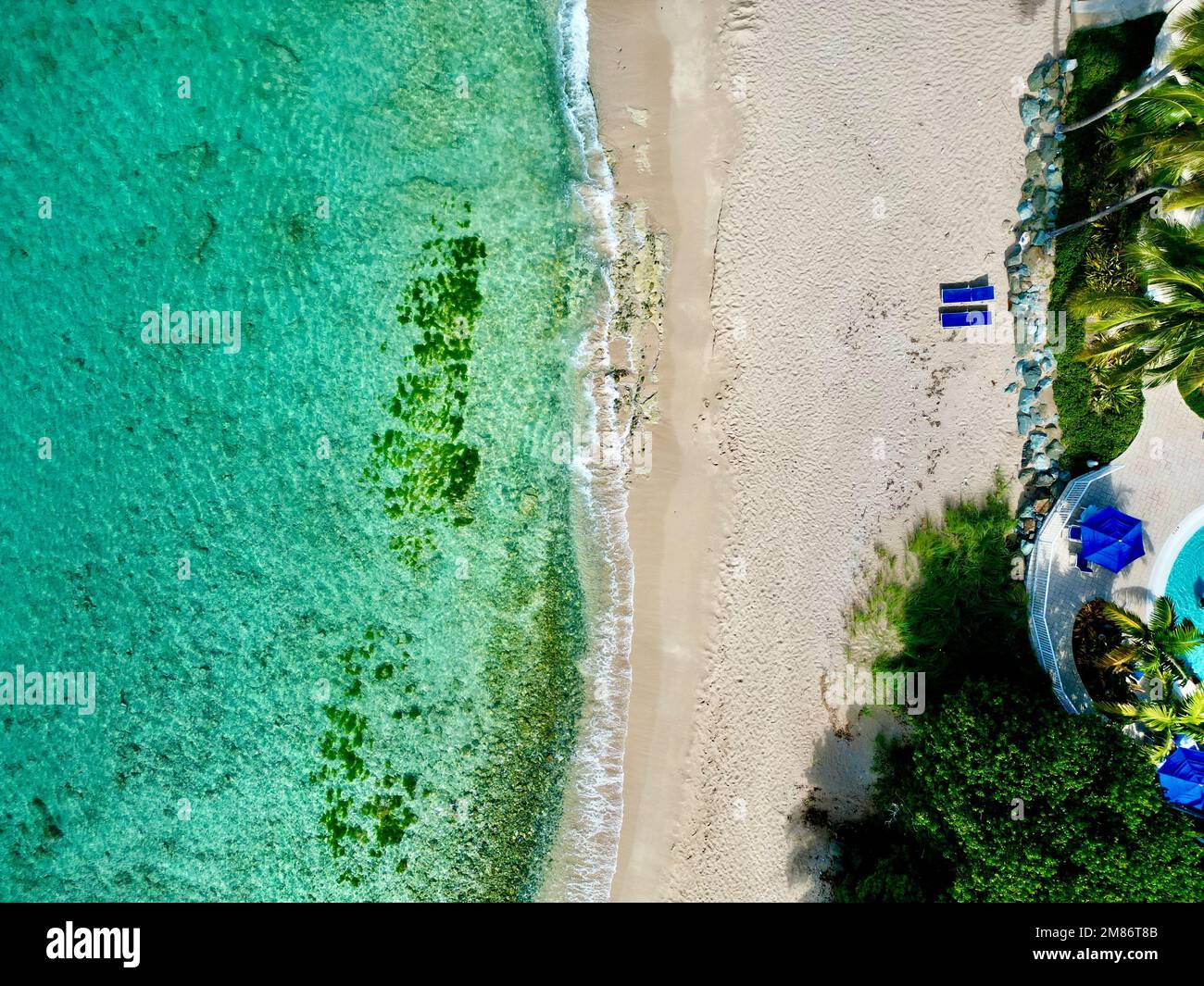 An aerial shot of a crystal clear turquoise beach with white sand at St ...
