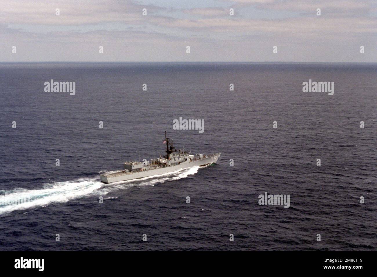 An elevated starboard quarter view of the frigate USS KOELSCH (FF-1049 ...