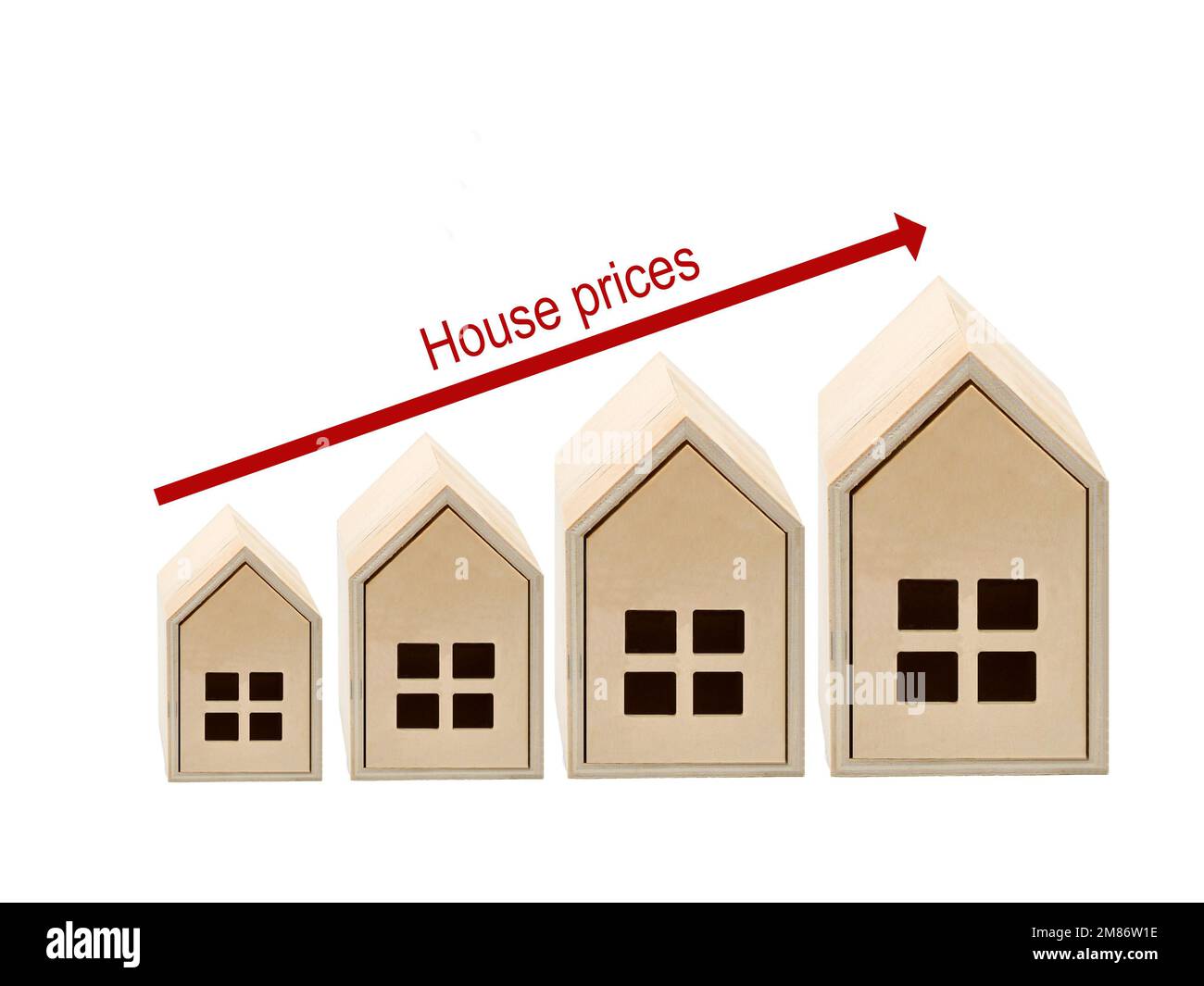 Row of model houses of different sizes on a plain white background ...