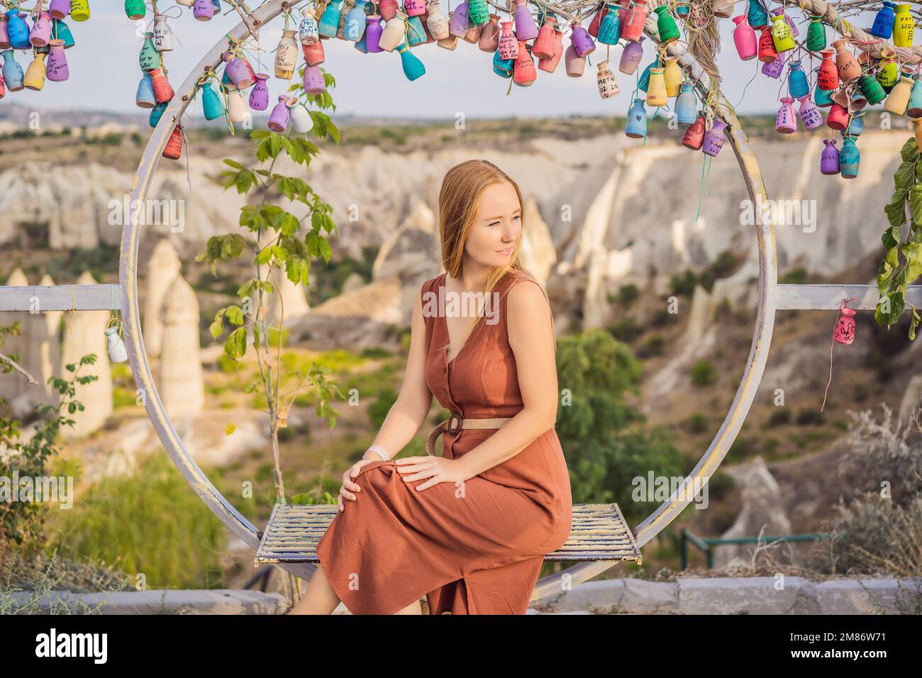 Young woman exploring valley with rock formations and fairy caves near ...