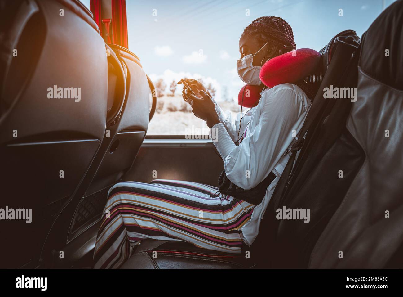 A portrait of a young black female in a white shirt and vertical ...
