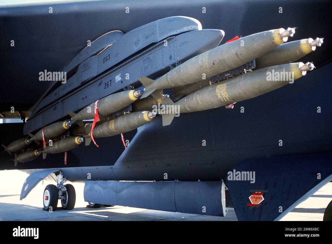 A view of 12 general purpose bombs loaded under the right wing of a ...