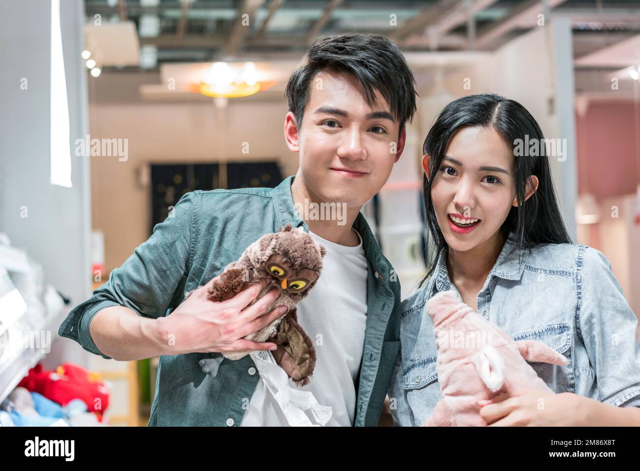 Young couples choose cartoon dolls Stock Photo - Alamy