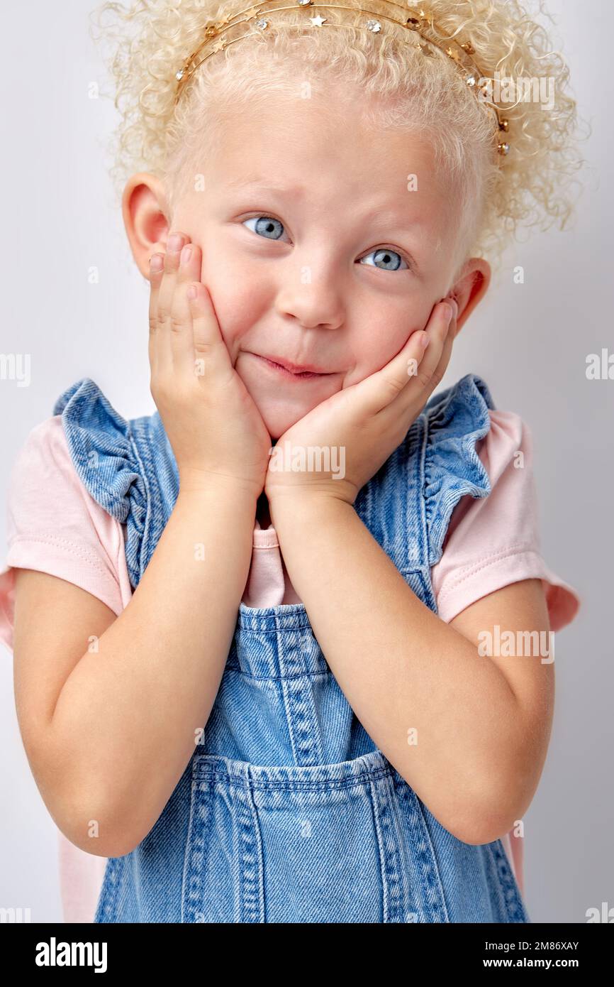 Wow. Surprised and excited child touching cheeks, isolated over white ...