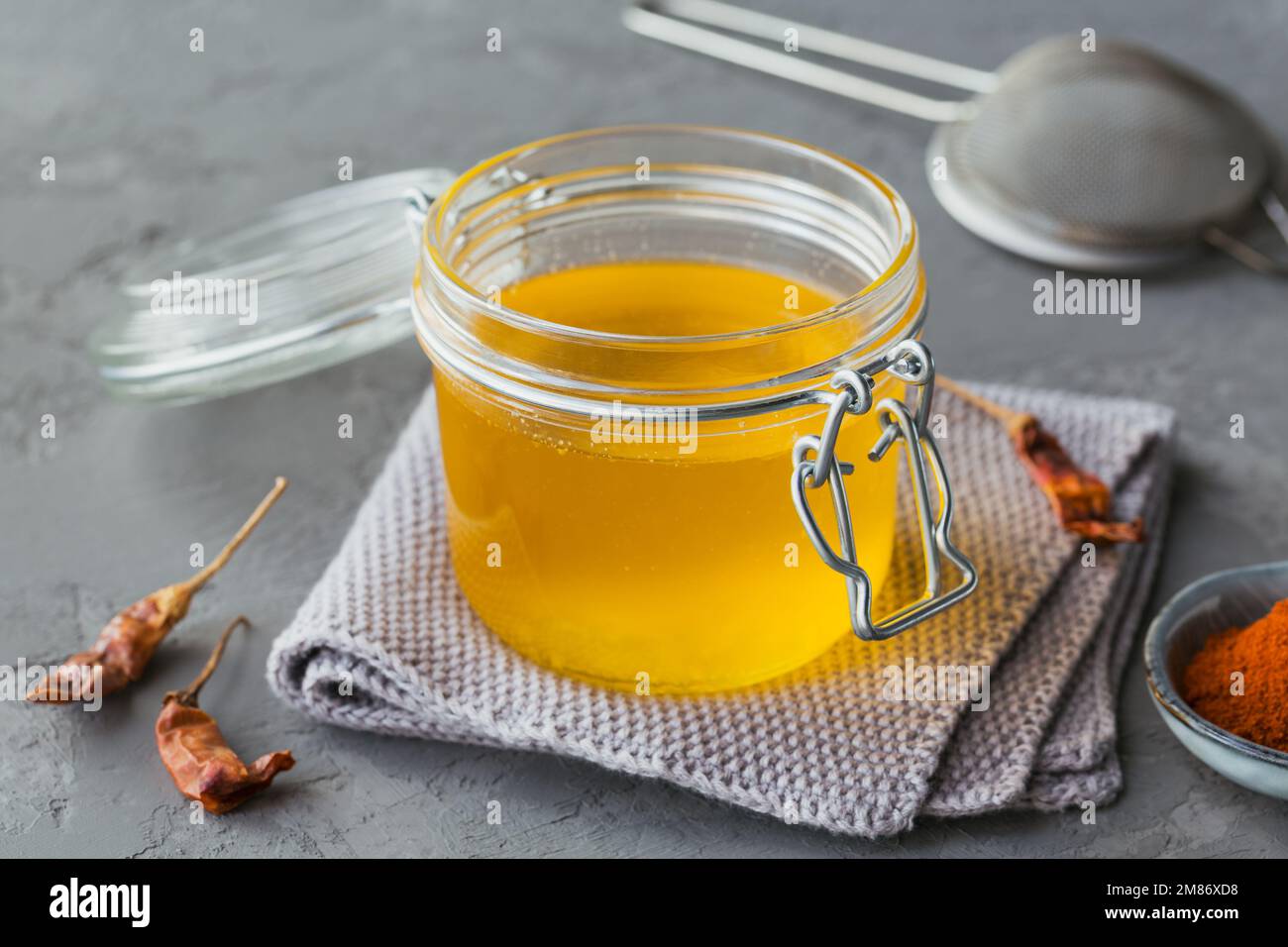 Healthy homemade Ghee or clarified butter in a jar, chili and paprika ...