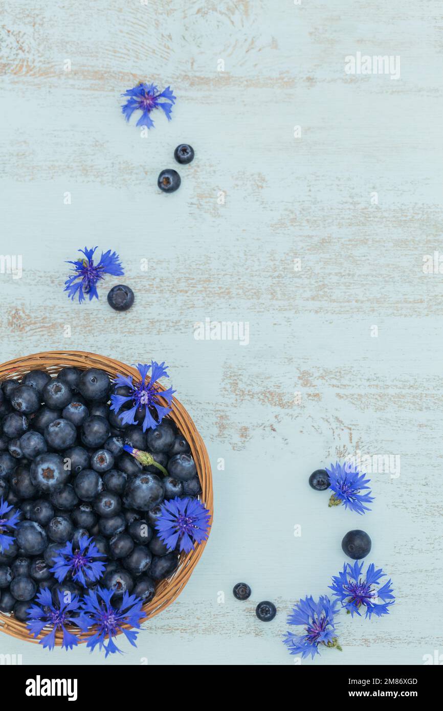 Fresh blueberries in basket with flowers pattern top view. Healthy food ...